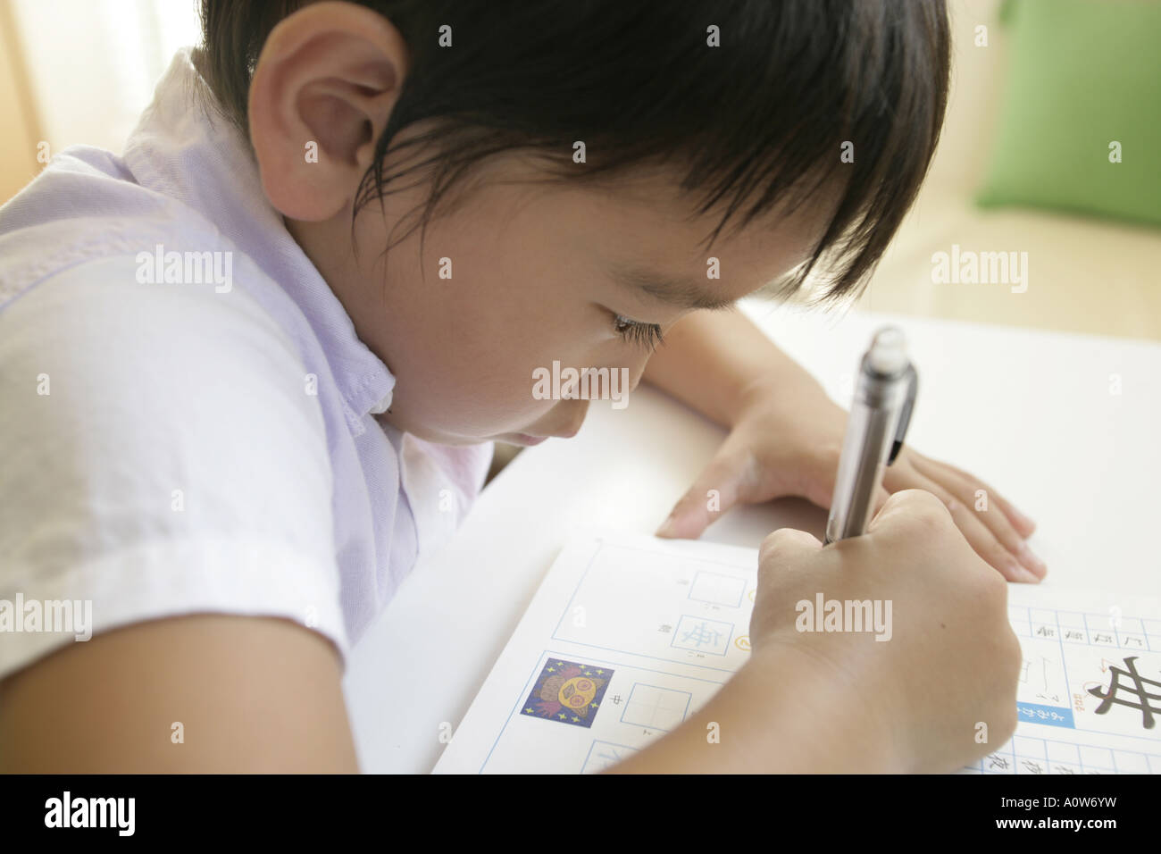 Side view asian boy writing hi-res stock photography and images - Alamy