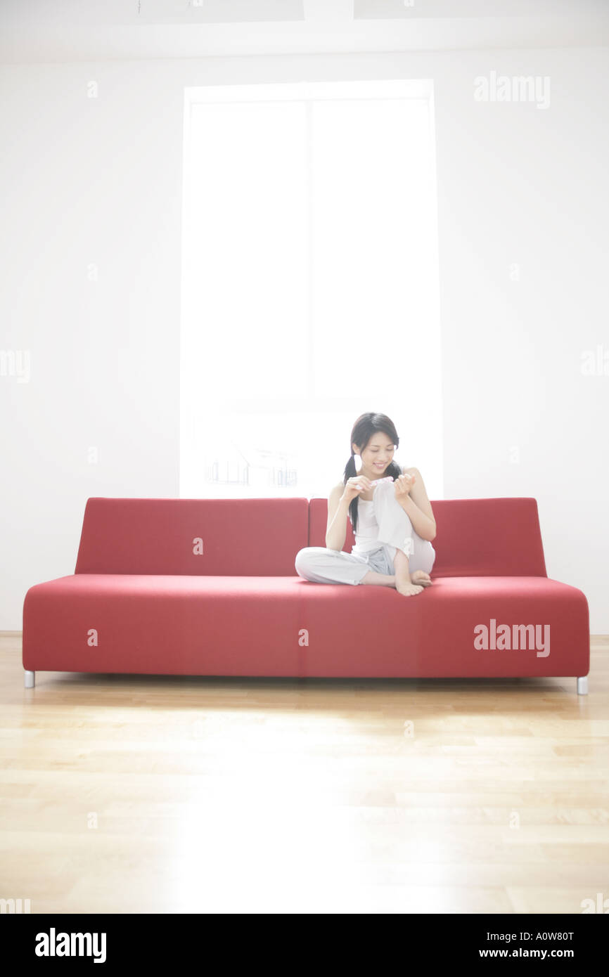 Young woman filing her nails and smiling Stock Photo - Alamy