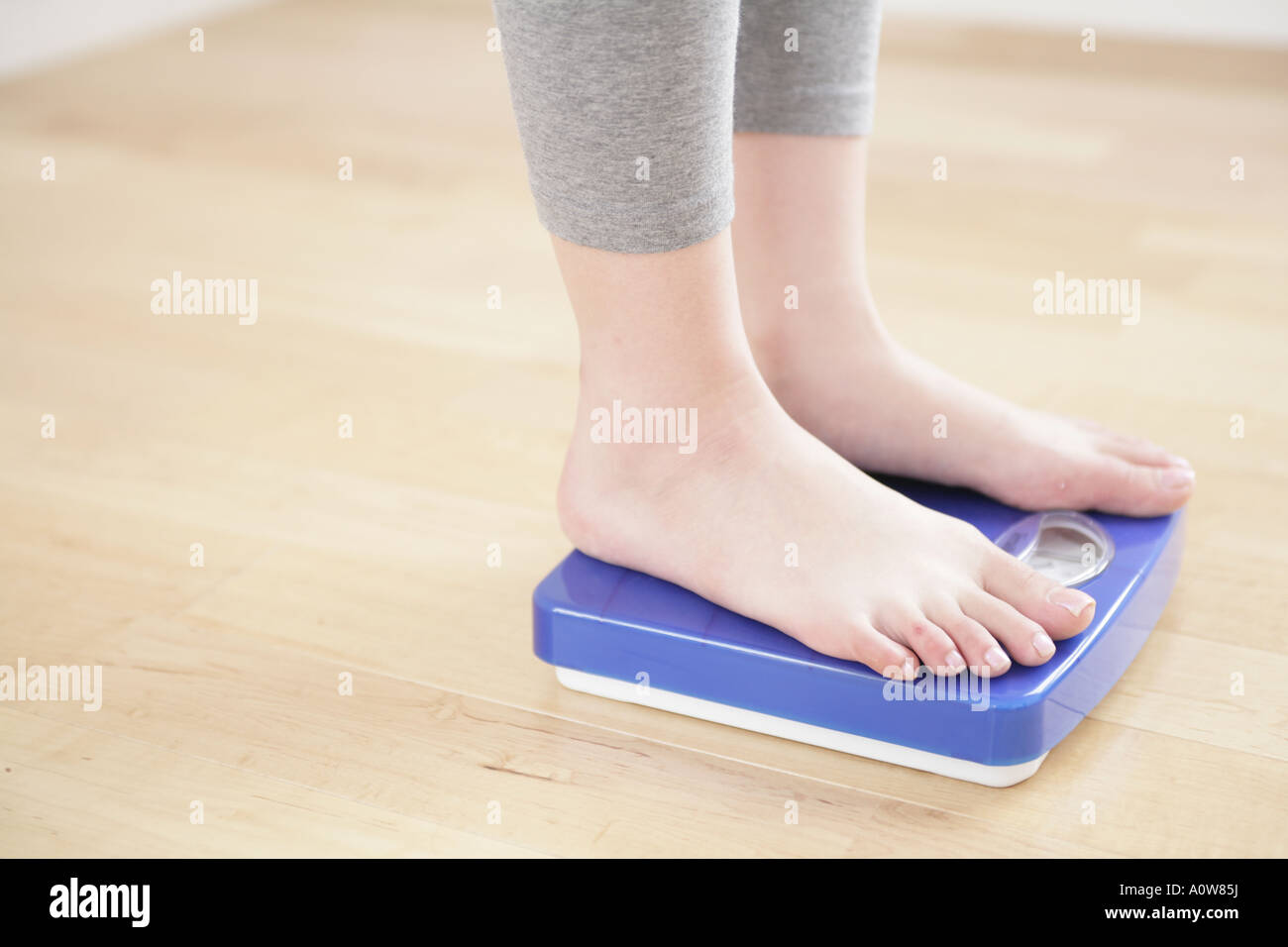 Low section view of a person standing on a weighing scale Stock Photo ...