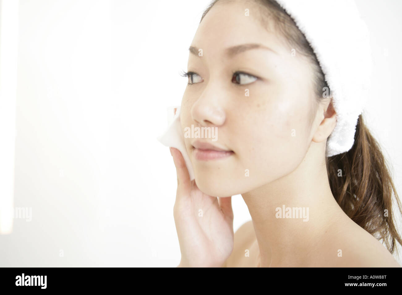 Close up of a young woman cleaning her face with a tissue paper Stock ...