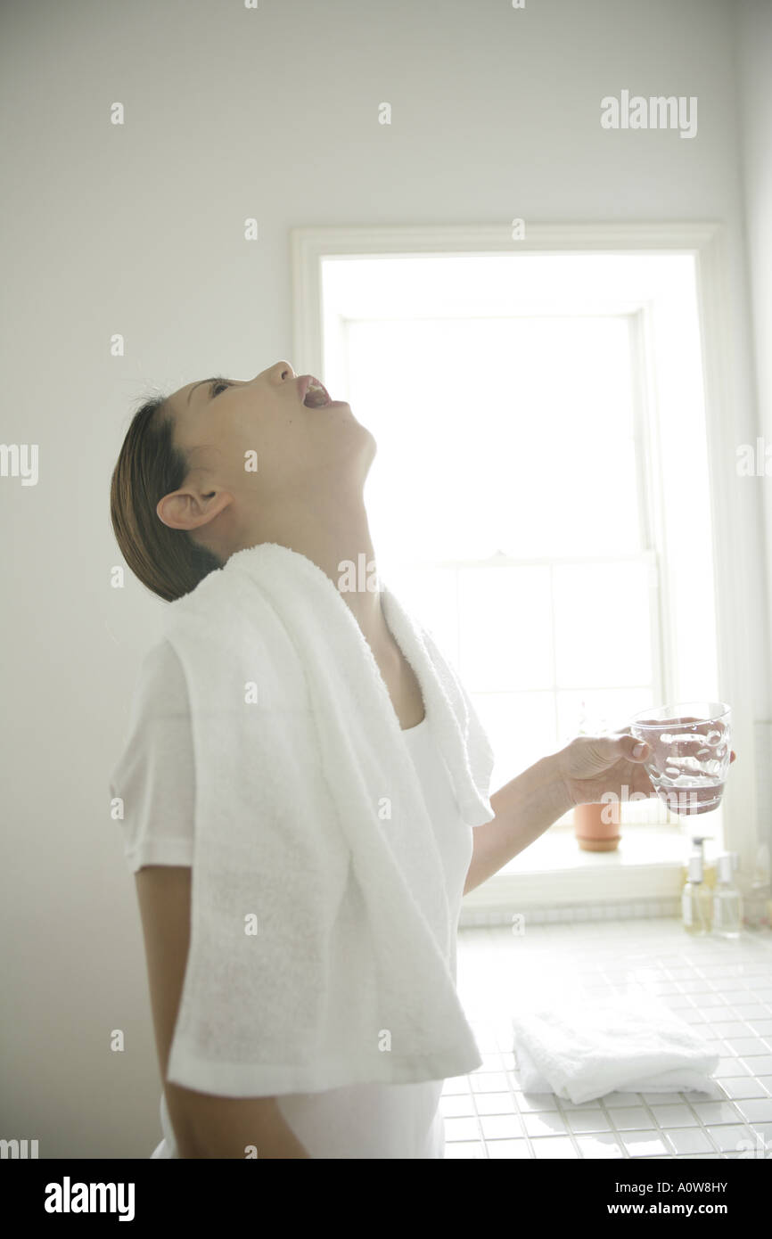Side profile of a young woman gargling Stock Photo - Alamy