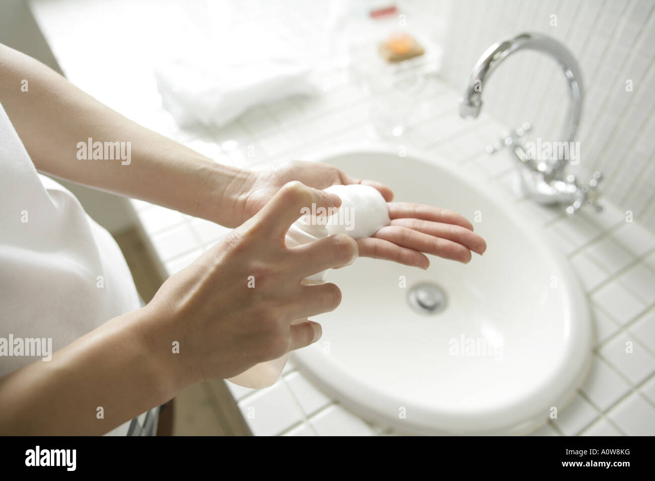 Mid section view of a man spraying soap on the palm of his hand Stock ...