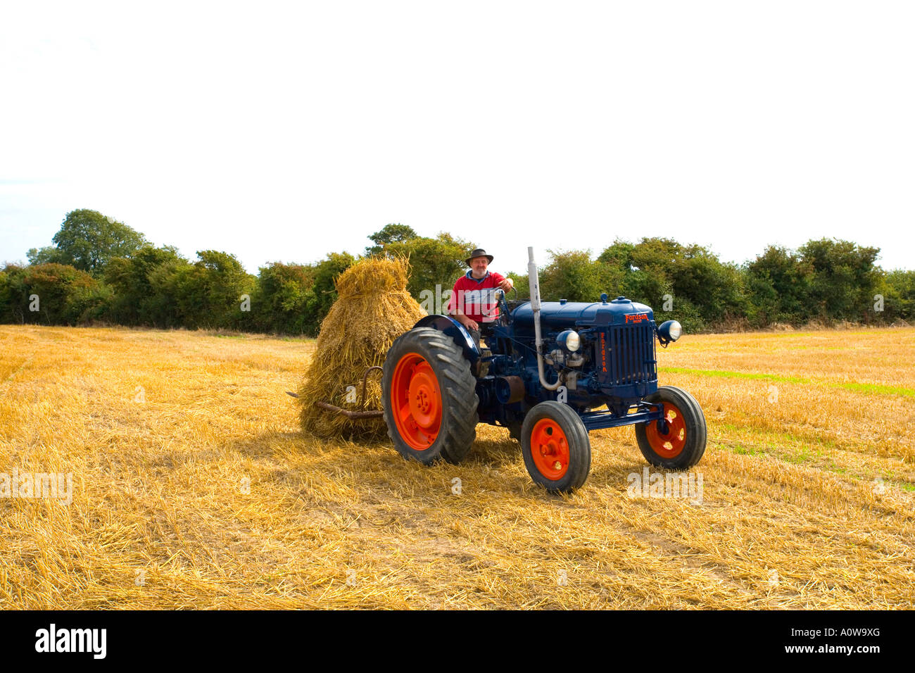 farmer saving the hay with his tractor in the field Stock Photo - Alamy