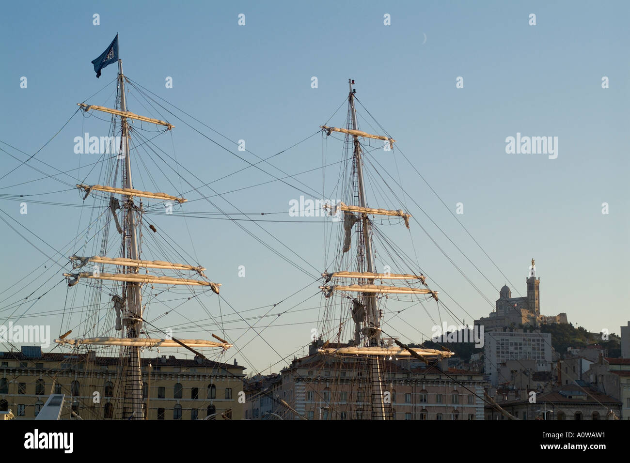 Ship masts of a belem sailing ship with Notre Dame de la Garde visible ...