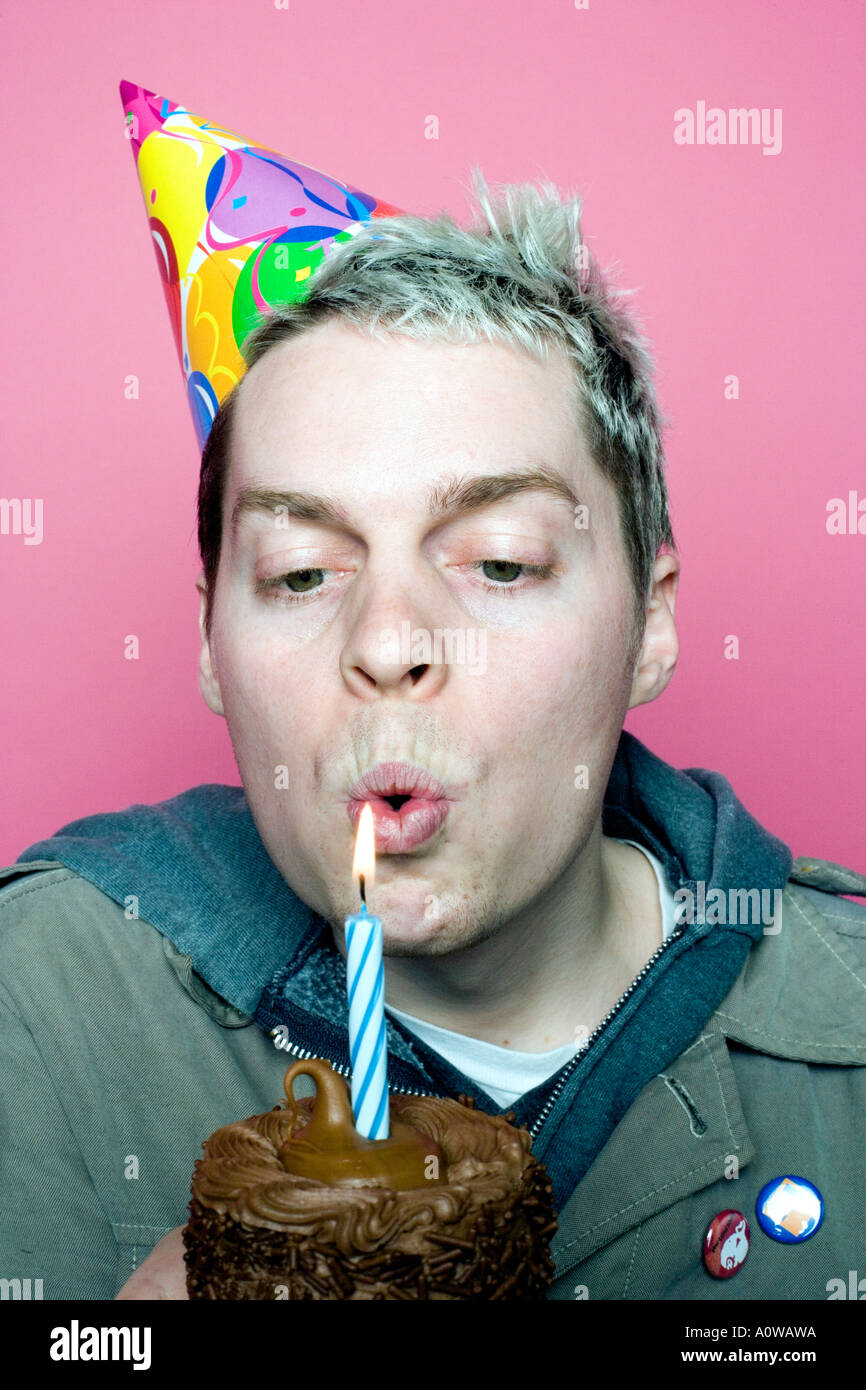 Portrait Caucasian man blowing out candle flame on birthday cake Stock ...