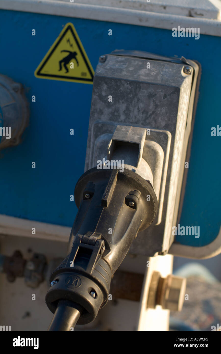Warning sign next to a power outlet Stock Photo - Alamy