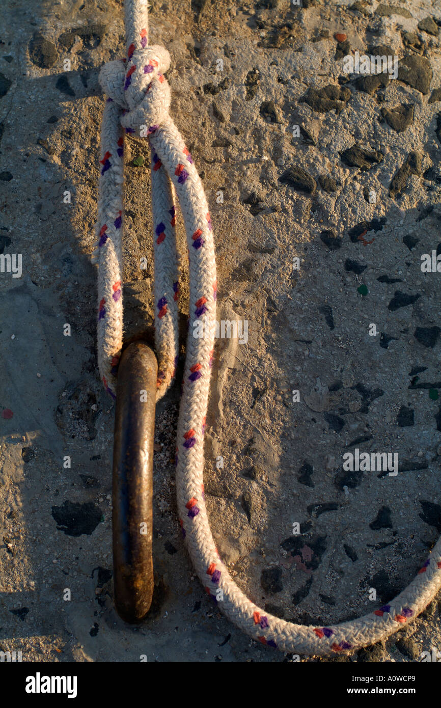Rope tied to a mooring ring Stock Photo - Alamy