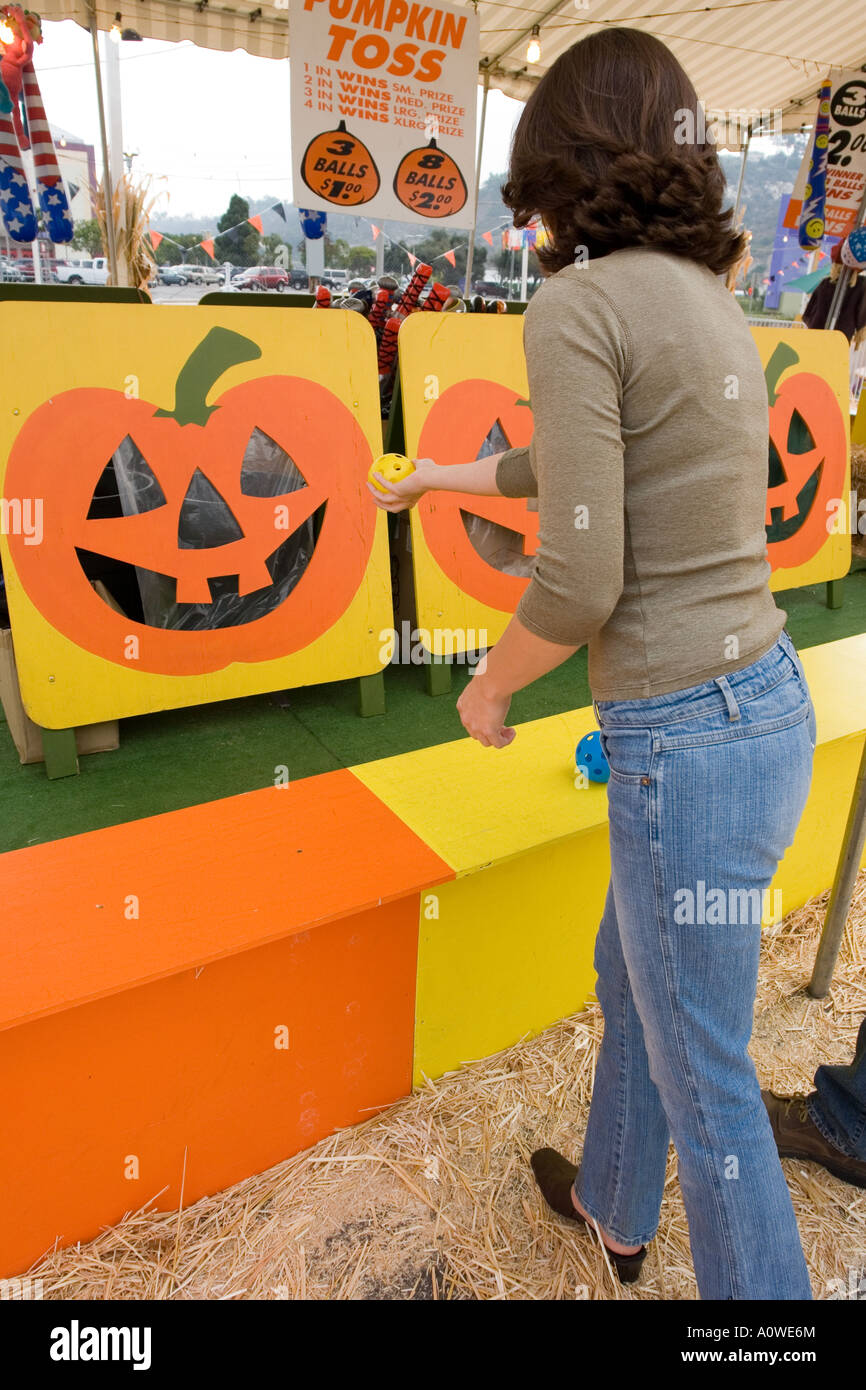 Woman playing throw toss at pumpkin Stock Photo - Alamy