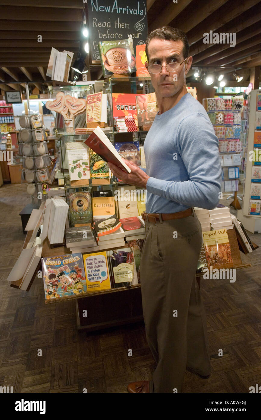Man reading book by bookstand Stock Photo - Alamy
