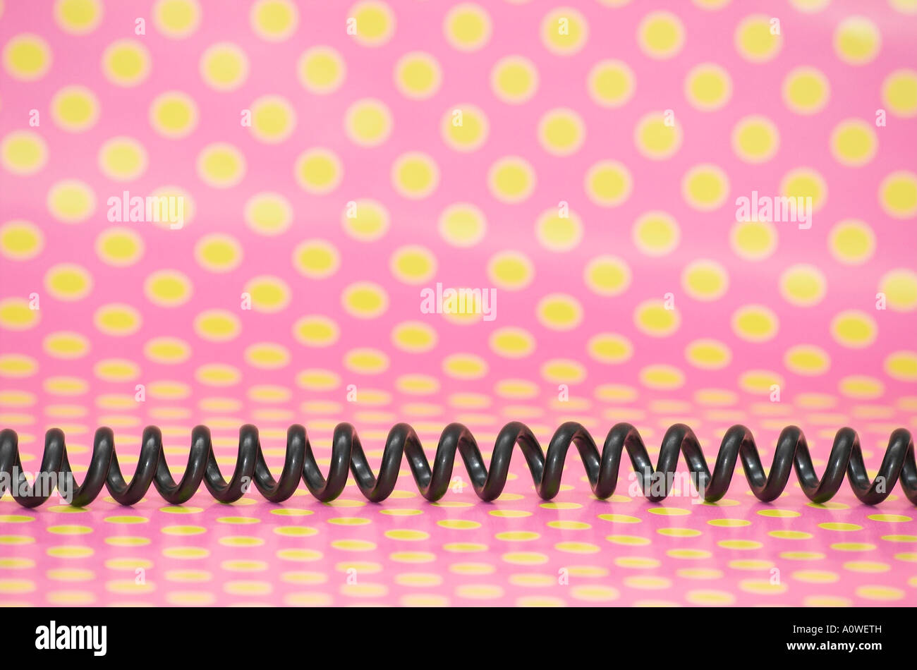 Telephone cord on pink background Stock Photo - Alamy