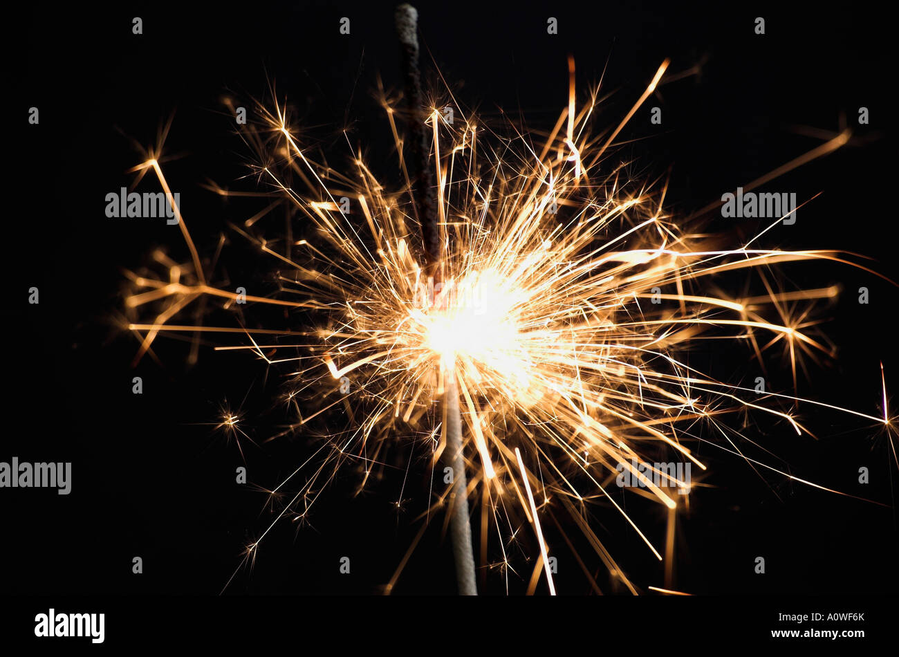 Sparkler against black background Stock Photo - Alamy