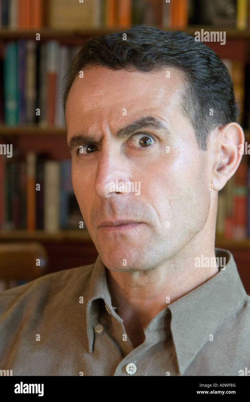 Portrait of man with raised eyebrow Stock Photo - Alamy