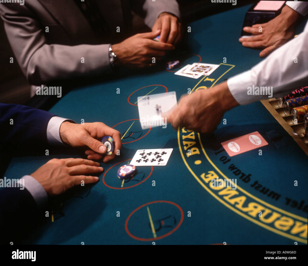 High Rollers Table men in suits with dealer in action drawing a card ...