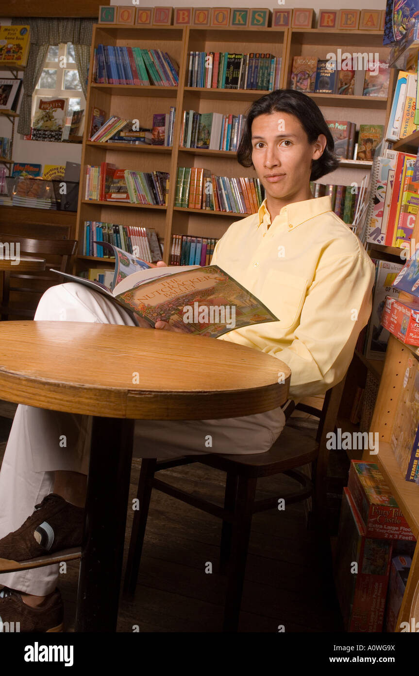 Portrait of young man reading a book Stock Photo - Alamy