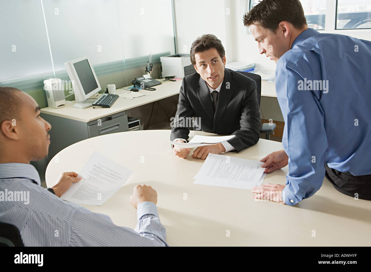 Businessmen discussing document Stock Photo - Alamy
