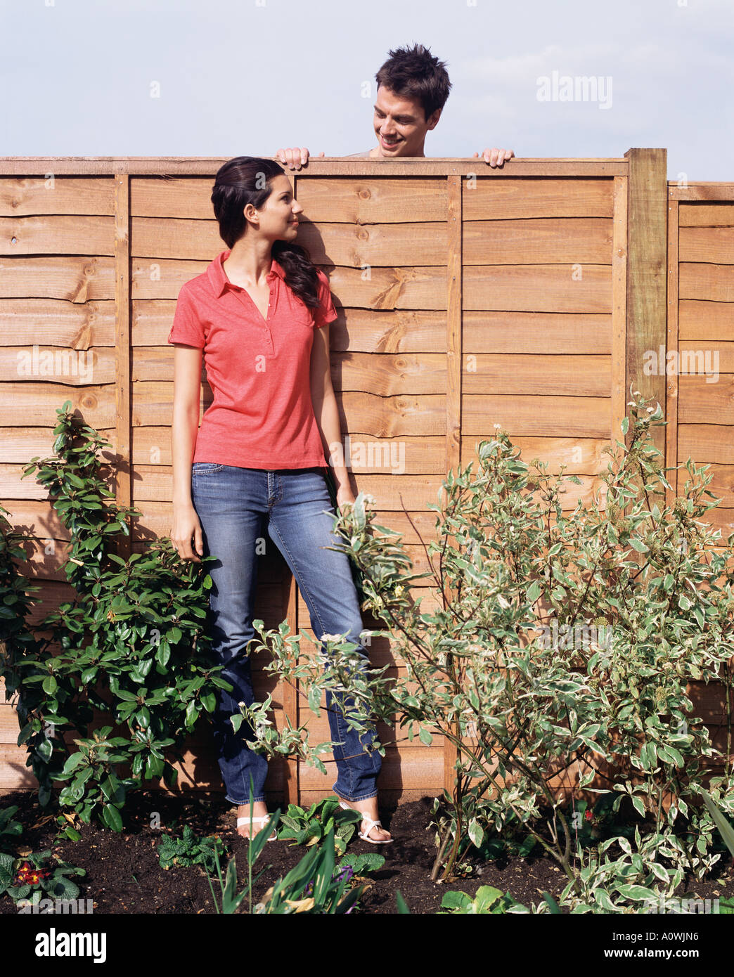 Neighbor looking over fence hi-res stock photography and images - Alamy