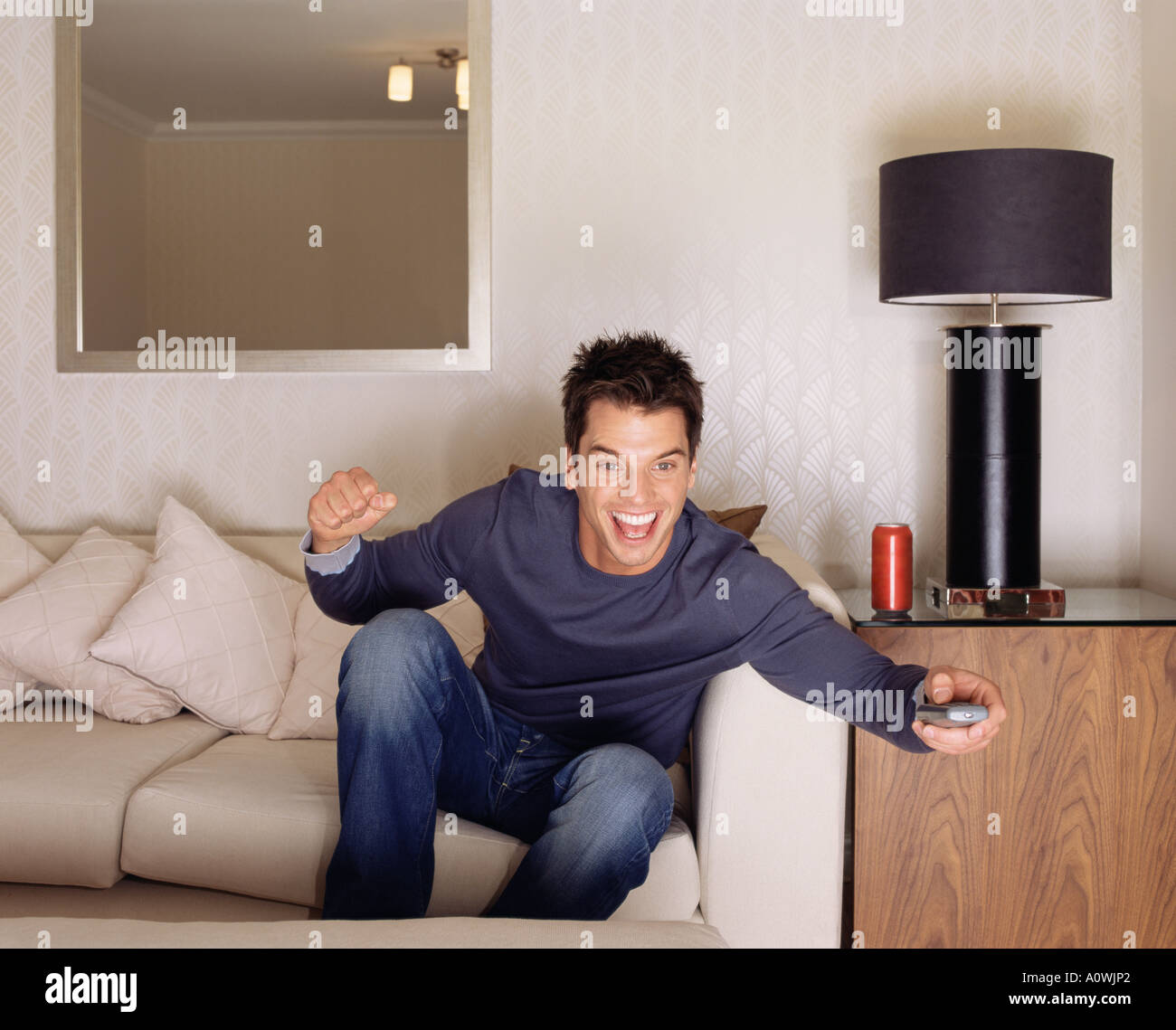 Excited man watching television Stock Photo - Alamy