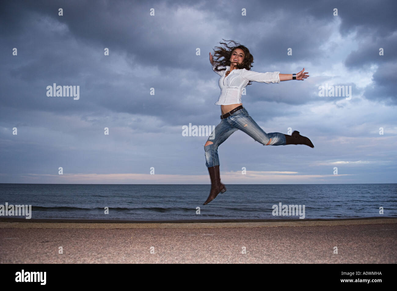 Woman jumping on beach Stock Photo - Alamy