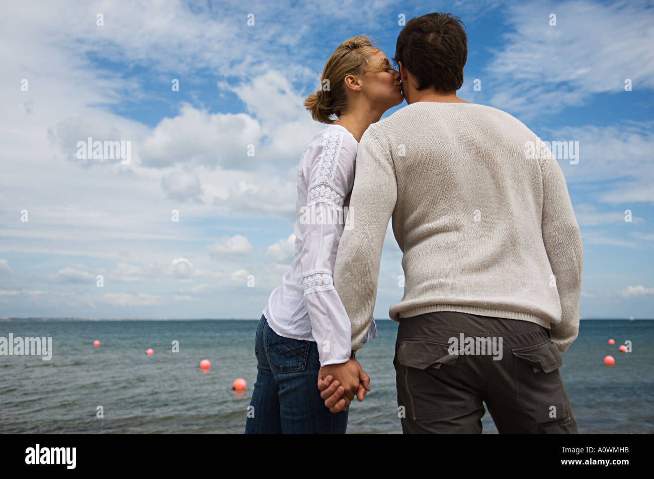 Romantic couple by the sea Stock Photo - Alamy