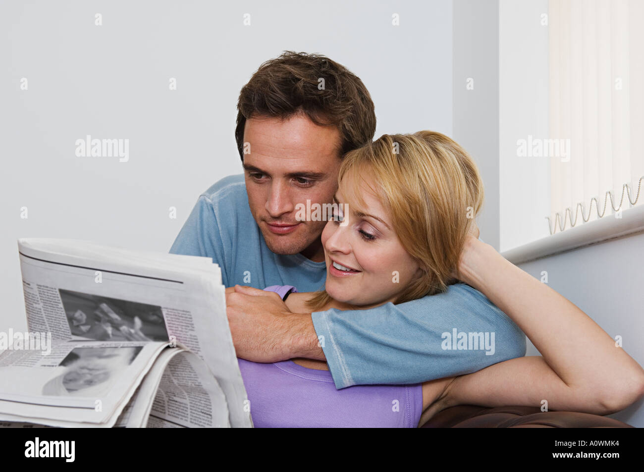 Couple reading a newspaper Stock Photo - Alamy