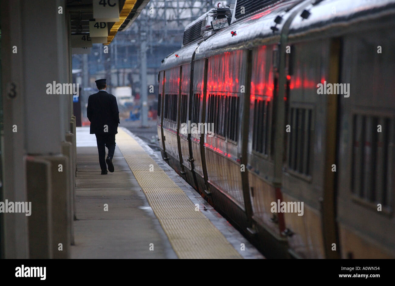 A Train conductor walks on a platform as the train prepares to leave ...