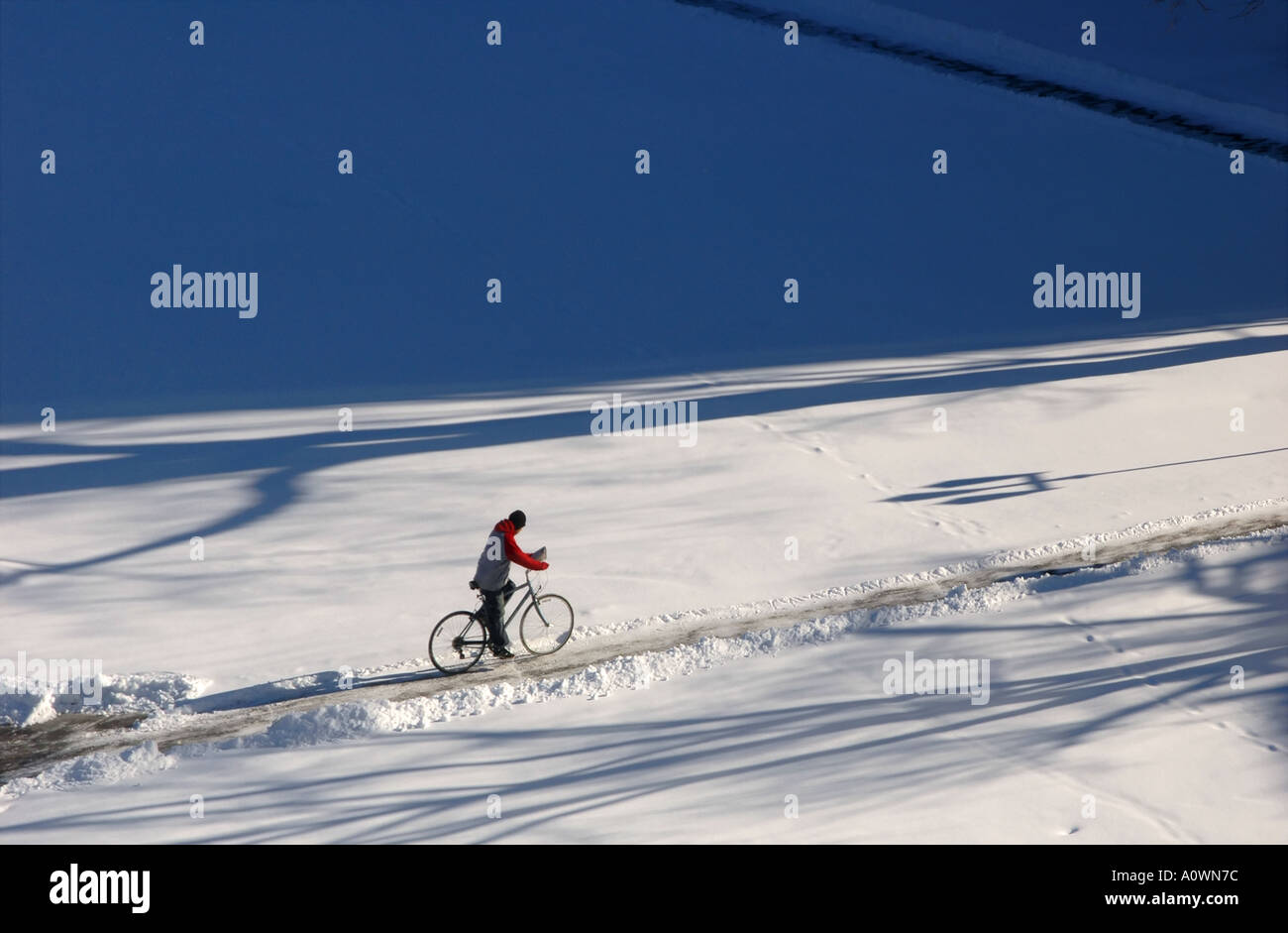 Bike rider in snow Stock Photo - Alamy