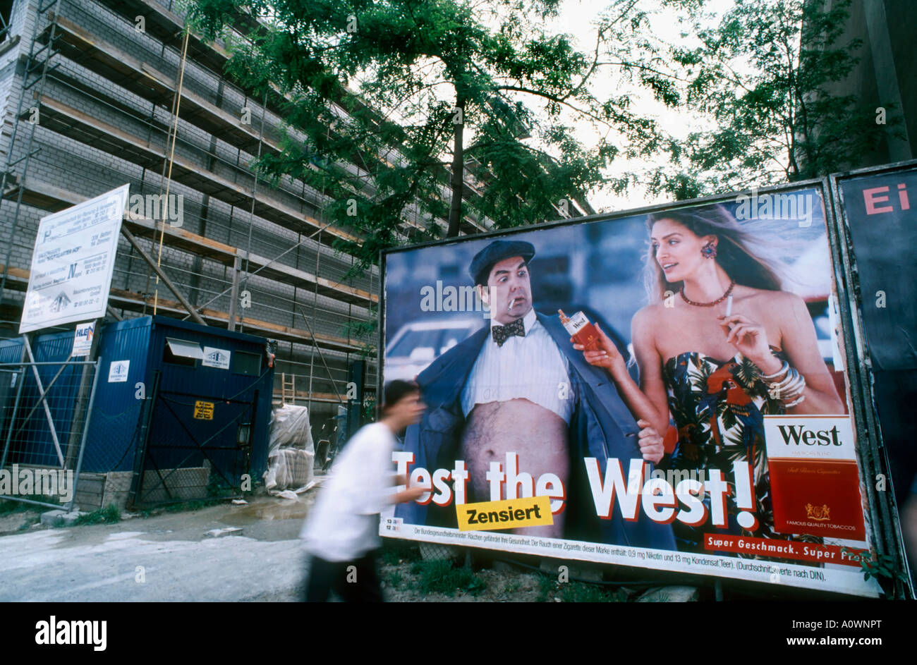 Berlin Germany, 1990's, Man passing Outdoor Advertising on Building ...