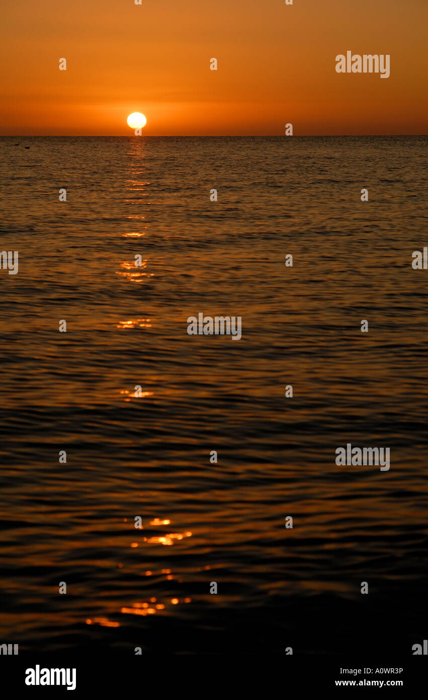 Sun setting over the sea Stock Photo - Alamy