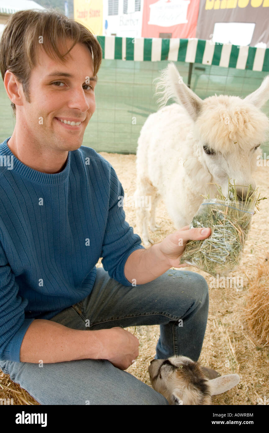 Man with petting zoo animal Stock Photo - Alamy