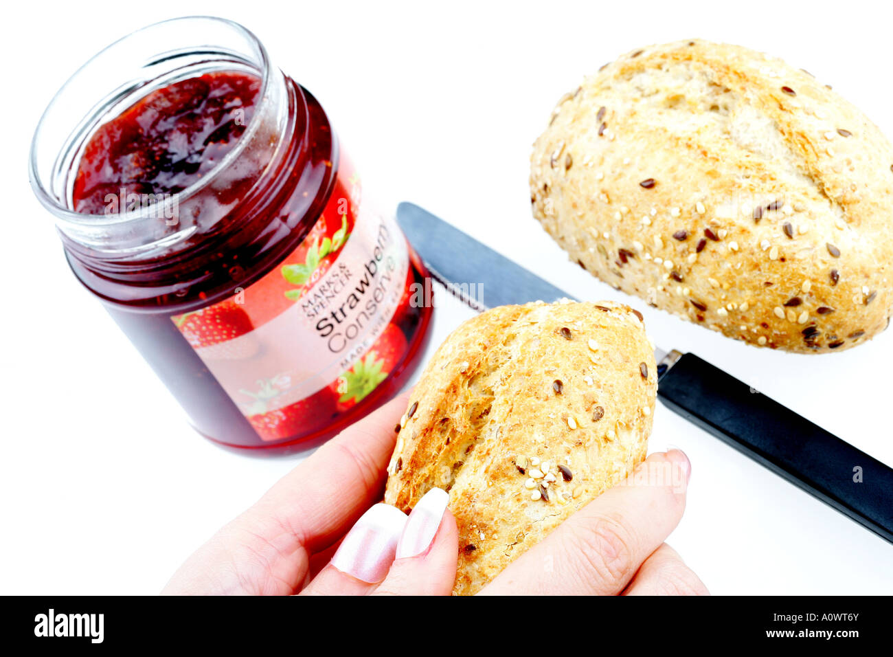 Spreading Jam on a Roll Stock Photo - Alamy