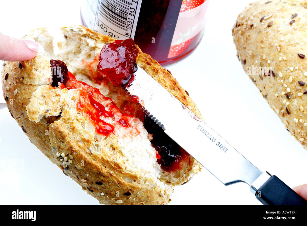 Spreading Jam on a Roll Stock Photo - Alamy