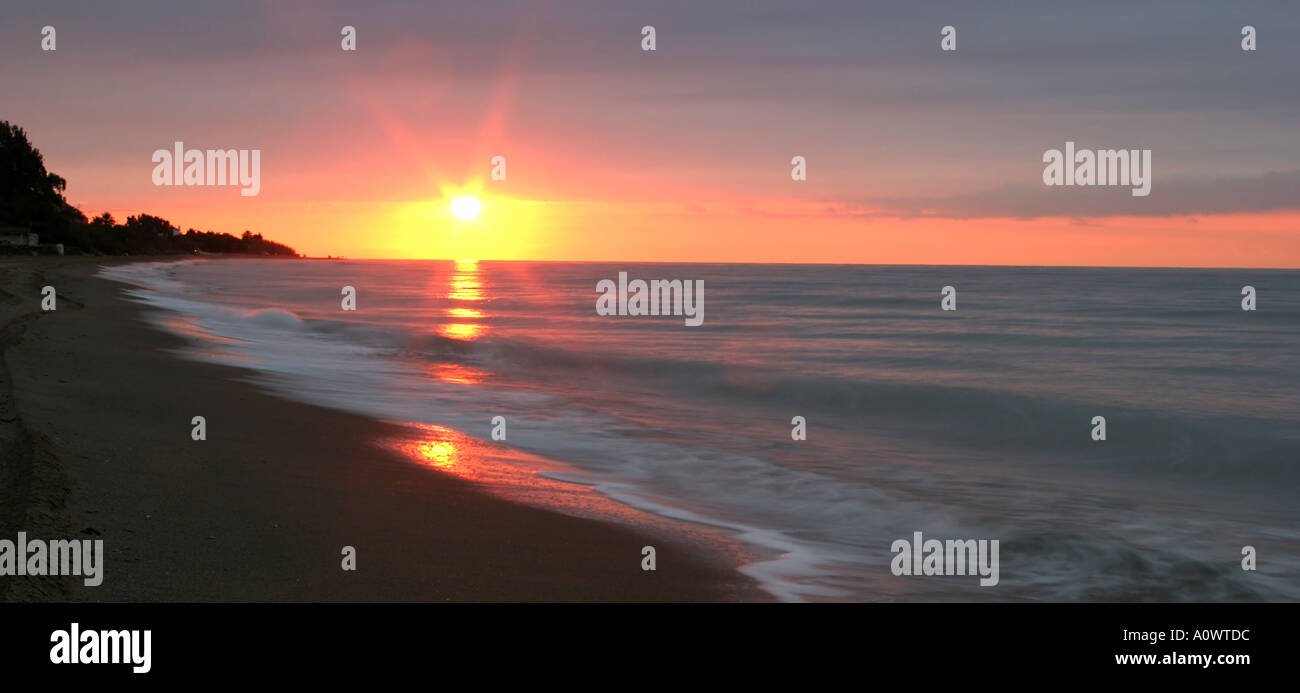 Beautiful golden yellow orange glow from sun rising from the horizon ...