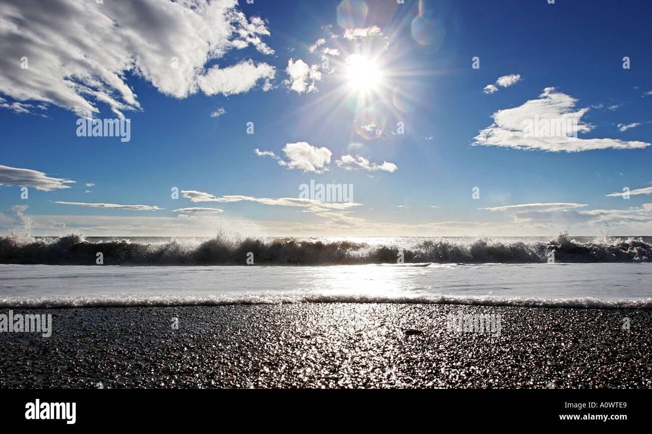 Sunny beach in Spain with blue sky and big waves Stock Photo - Alamy