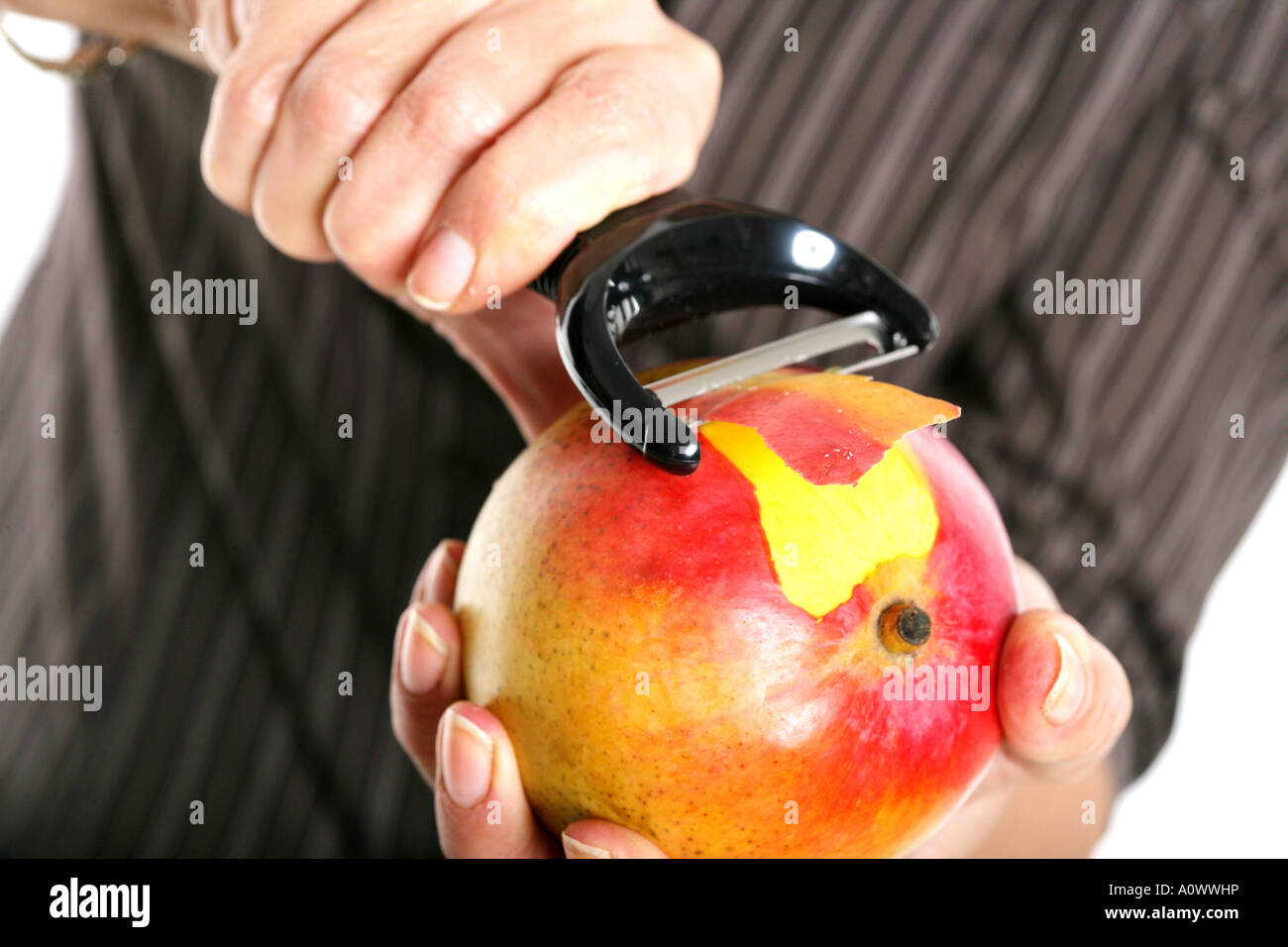 Woman Peeling A Mango Model Released Stock Photo - Alamy