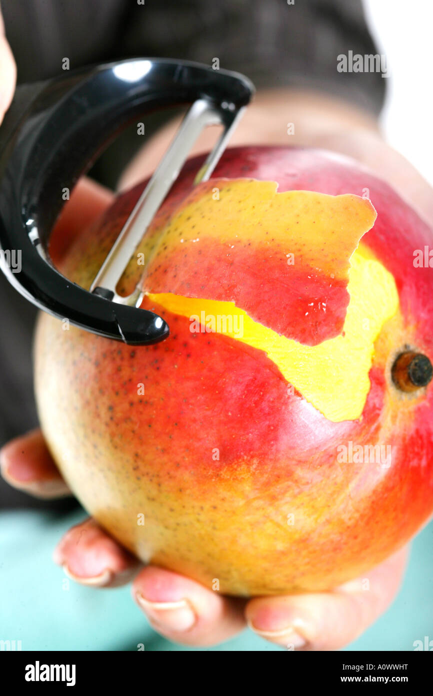 Woman Peeling A Mango Model Released Stock Photo - Alamy