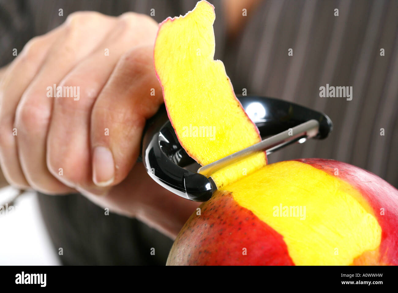 Woman Peeling A Mango Model Released Stock Photo - Alamy