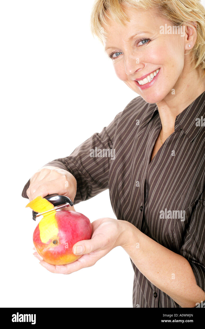 Mature Woman Peeling a Mango Model Released Stock Photo - Alamy