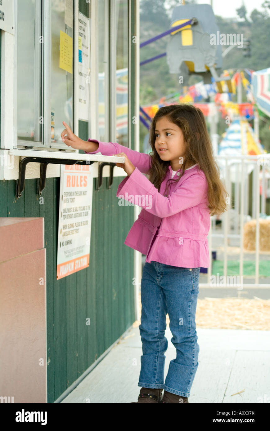Young girl at ticket booth Stock Photo - Alamy
