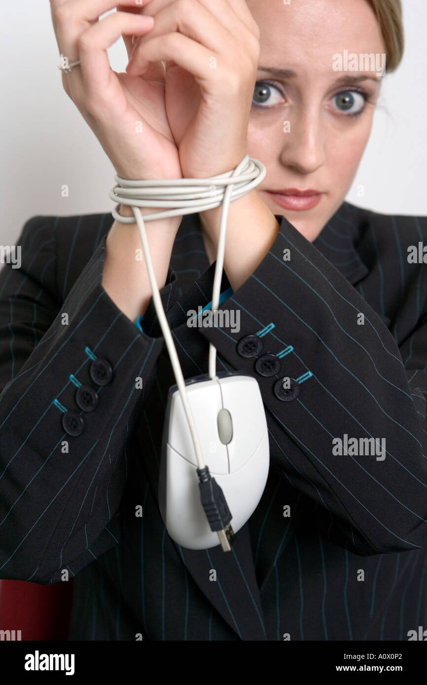 female executive office worker is tied to computer mouse Stock Photo ...