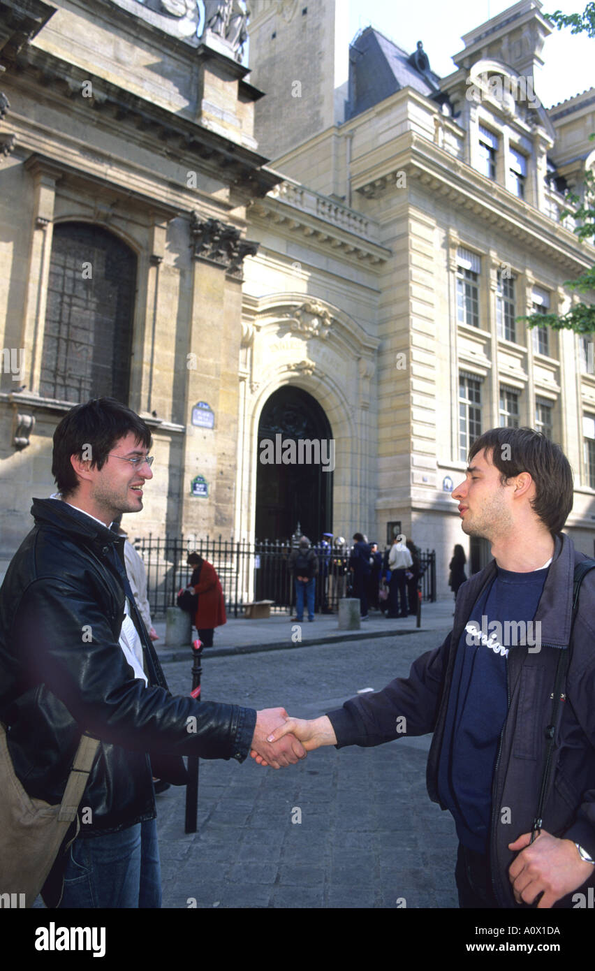 French students greet with a handshake Stock Photo - Alamy