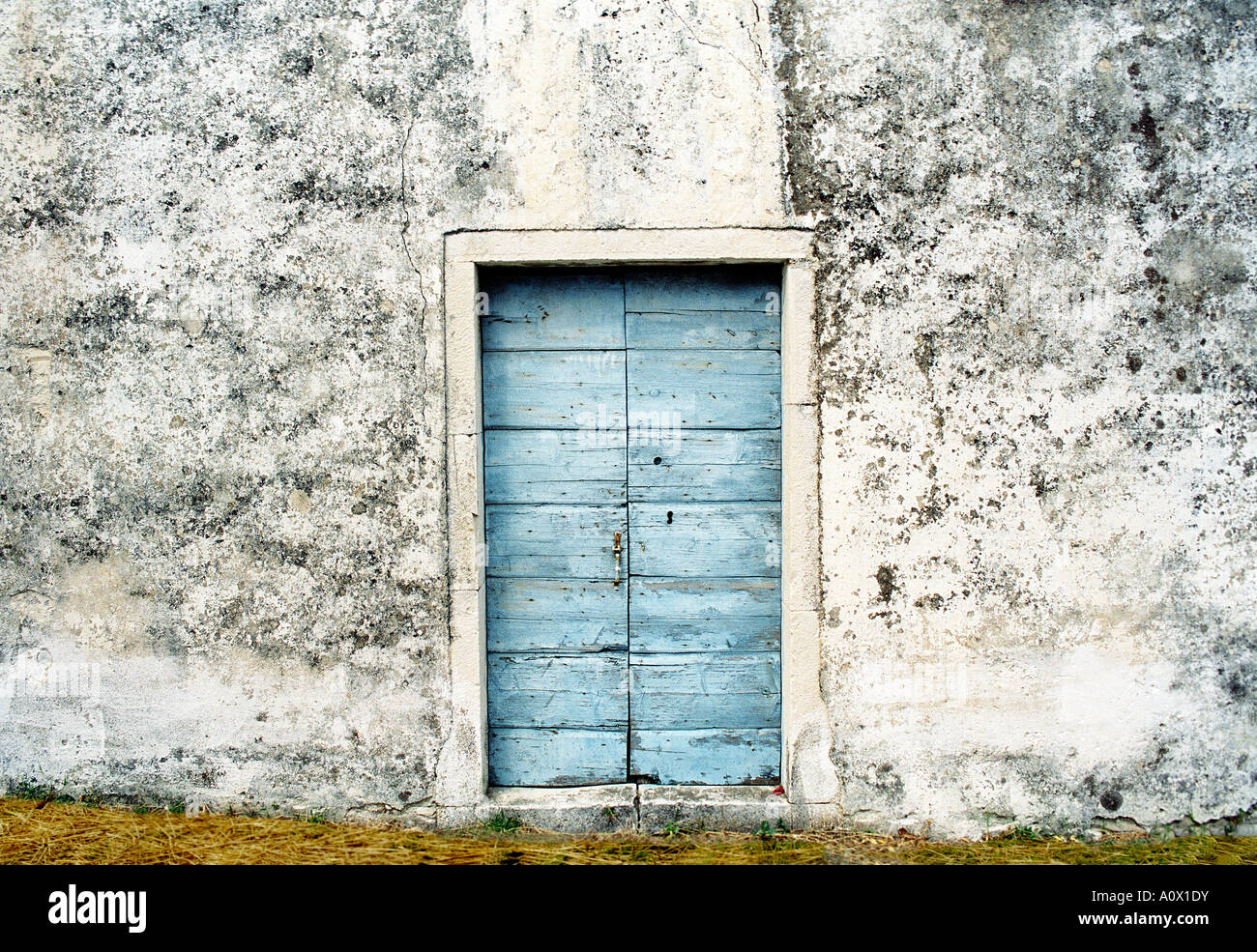 Old European style weather worn building with a mystery central blue ...