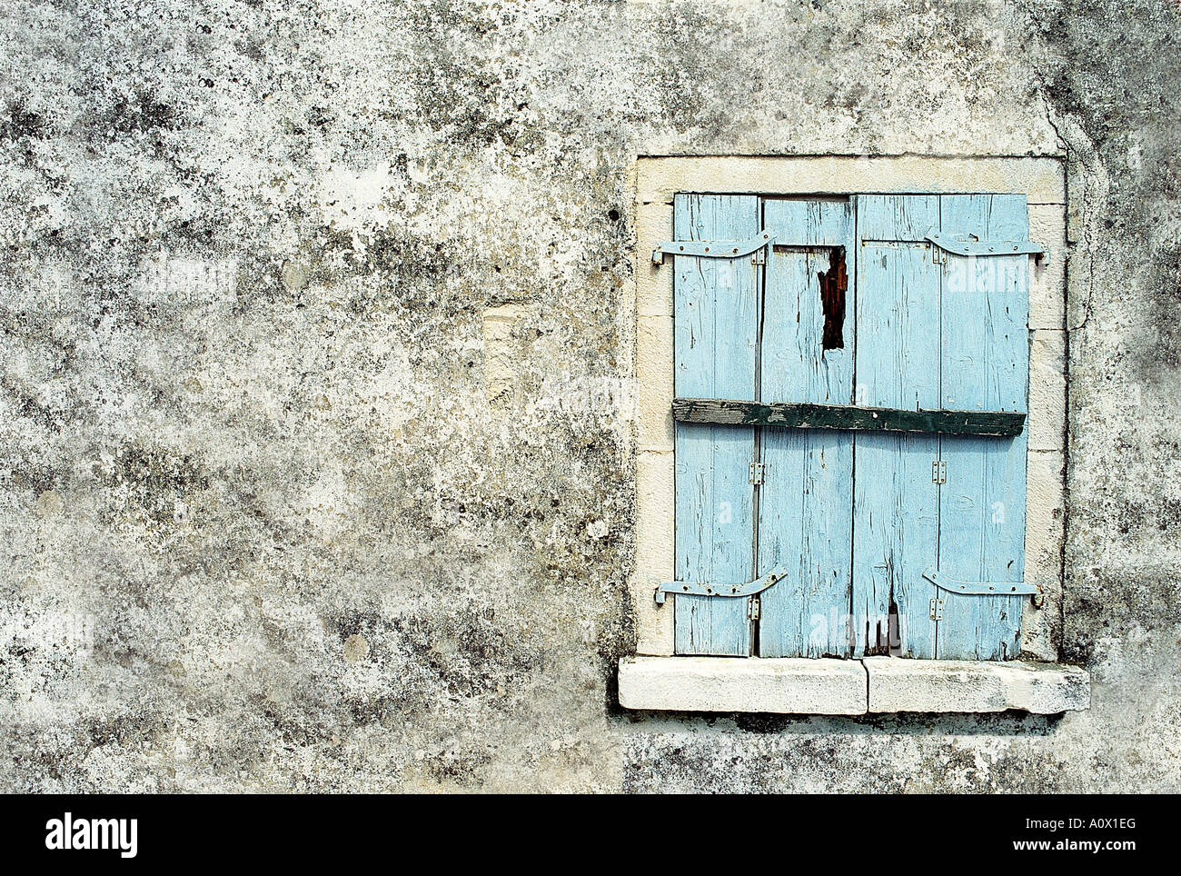 Old European style weather worn building with a mystery central blue ...