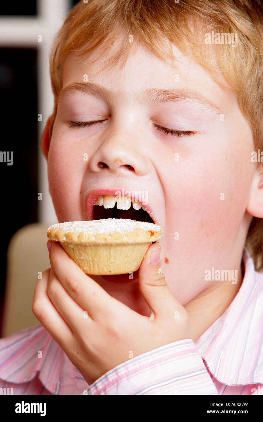 Young Boy Eating a Mince Pie Model Released Stock Photo - Alamy