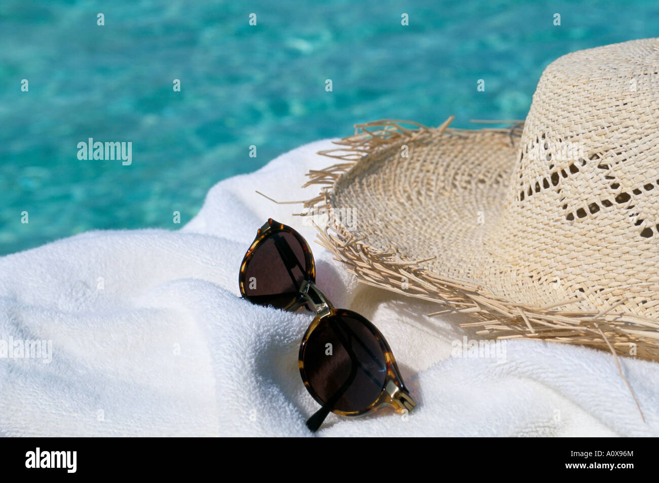 Straw hat and sunglasses on towel North Male Atoll Maldives Indian ...