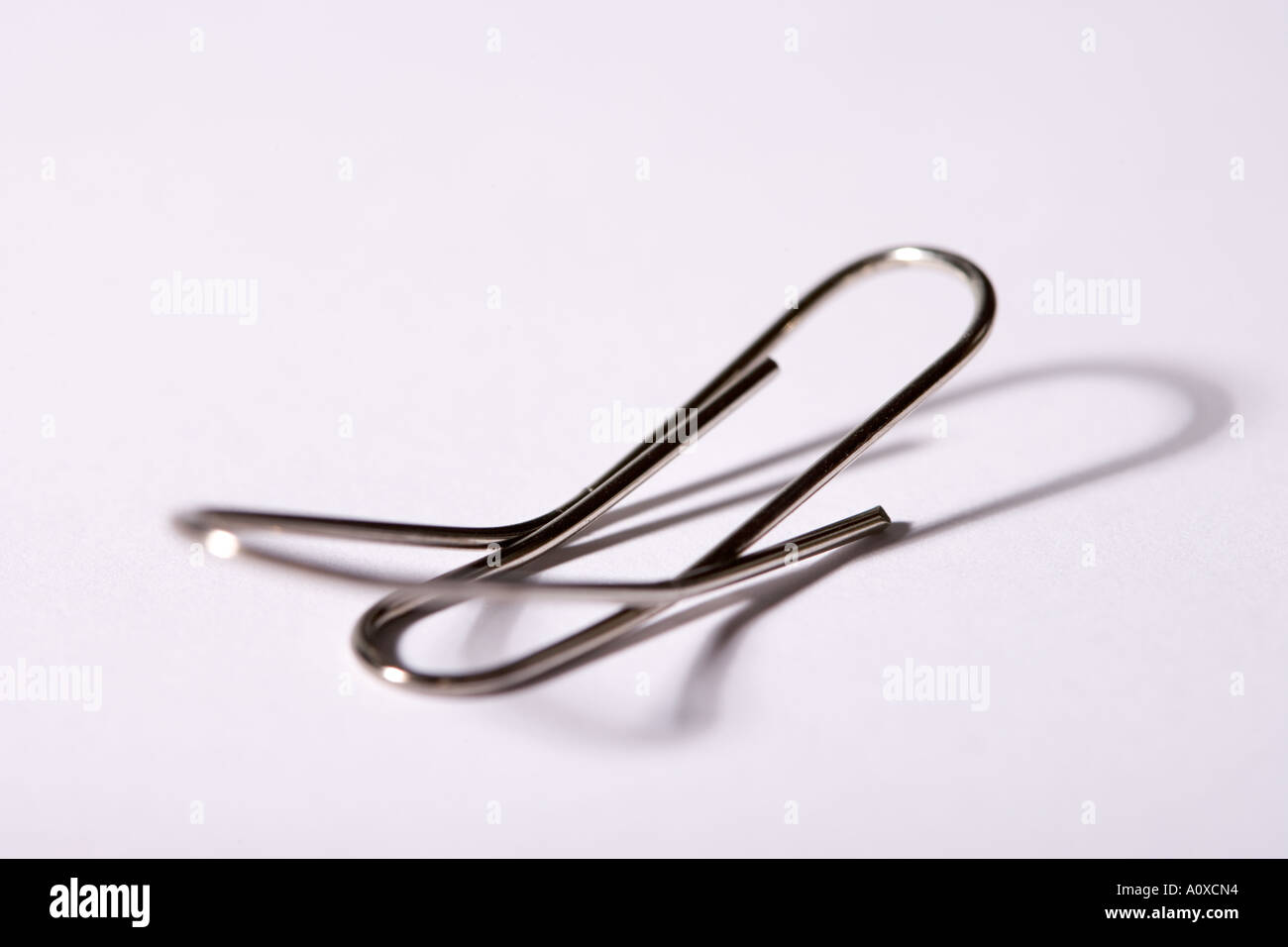 Bent paper clip Stock Photo - Alamy