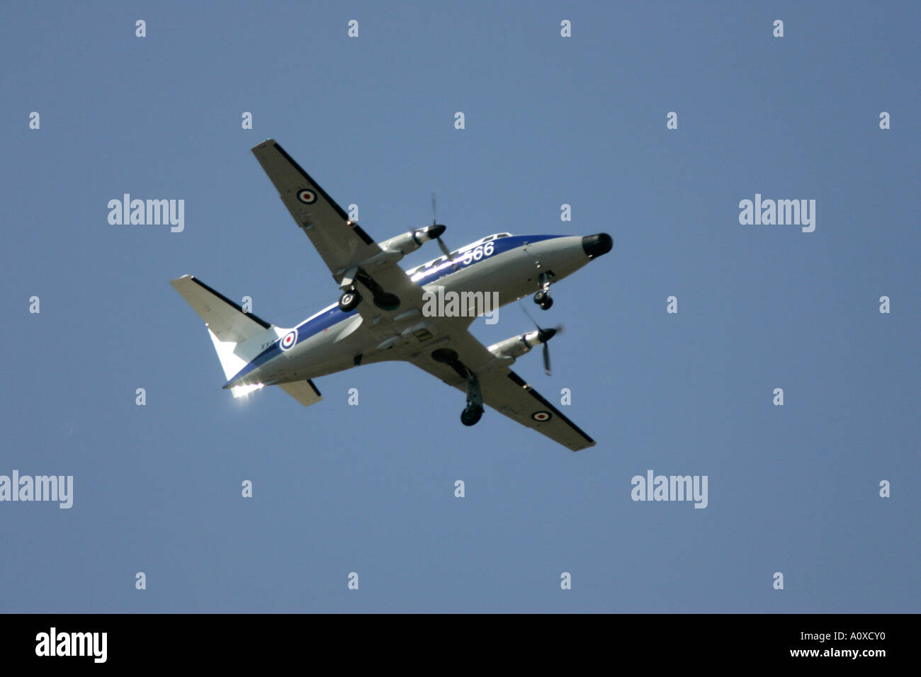 Royal Navy Jetstream T2 flies past in blue sky with undercarriage down ...