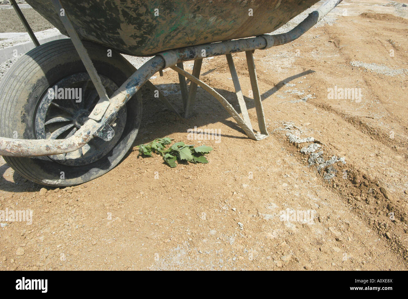 Construction cart wheel stepping on a plant Photo by Nano Calvo Stock ...