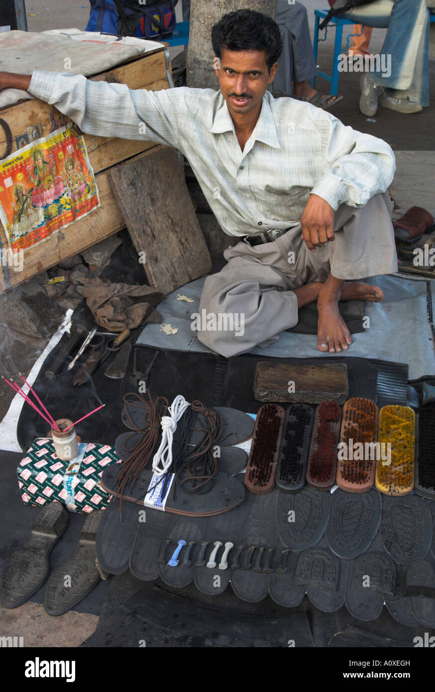 India Rajasthan Udaipur street shoe maker sitting on the floor at his ...
