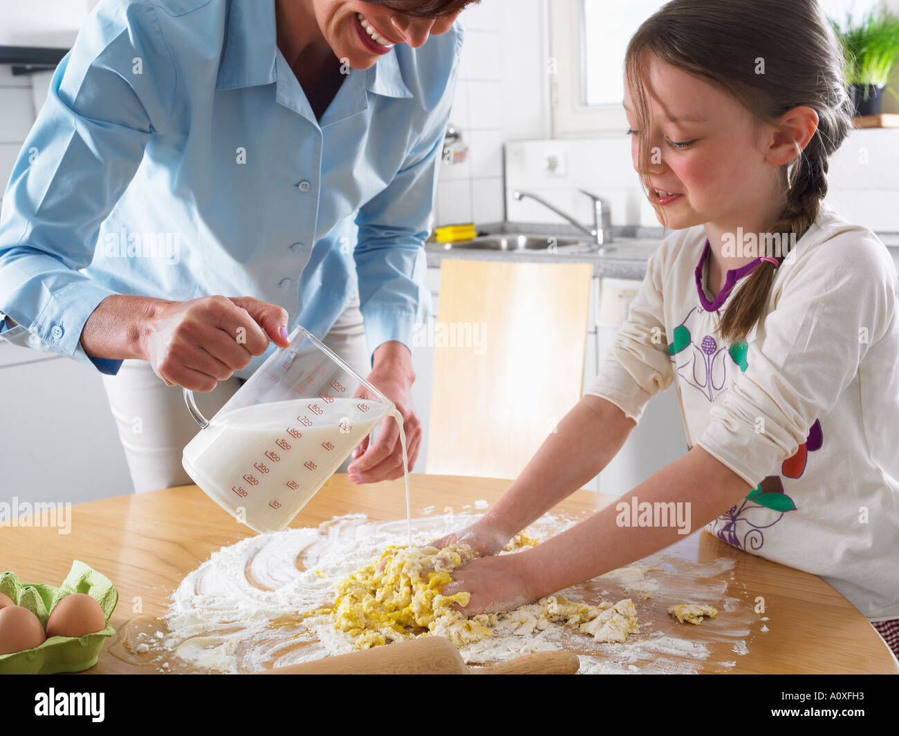 Mother and daughter mixing ingredients Stock Photo - Alamy