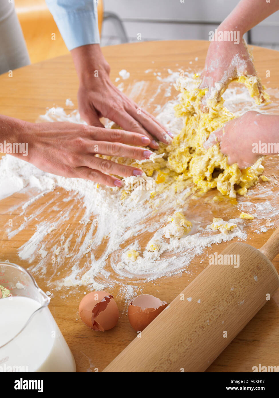 Woman and girl mixing ingredients Stock Photo - Alamy